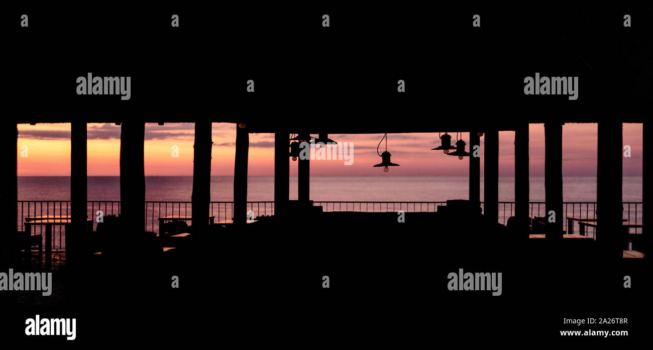 Beautiful sunset (sunrise) on a cafe background with lamps in retro ...