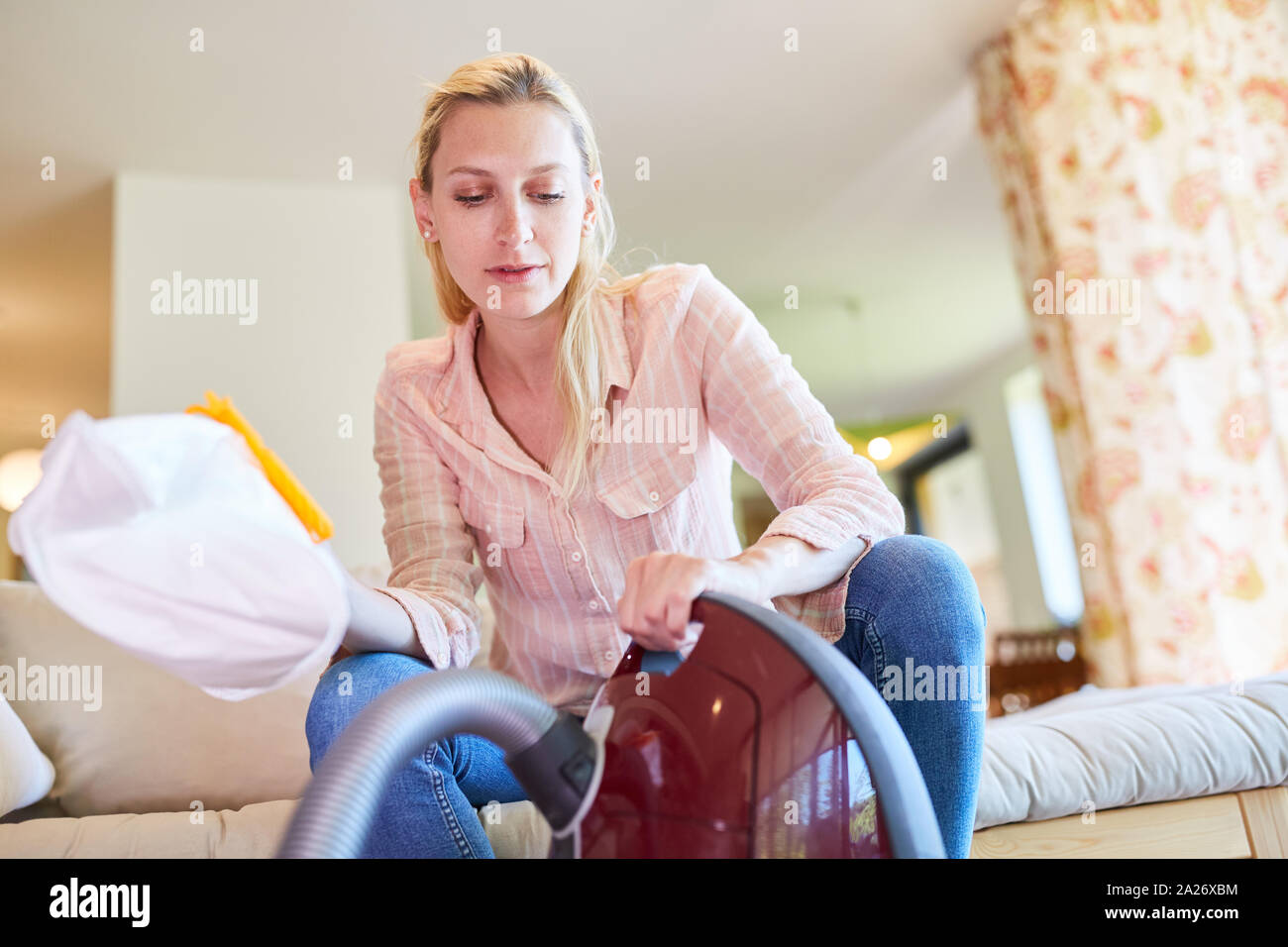 Housewife or cleaning lady changing the vacuum cleaner bag when ...