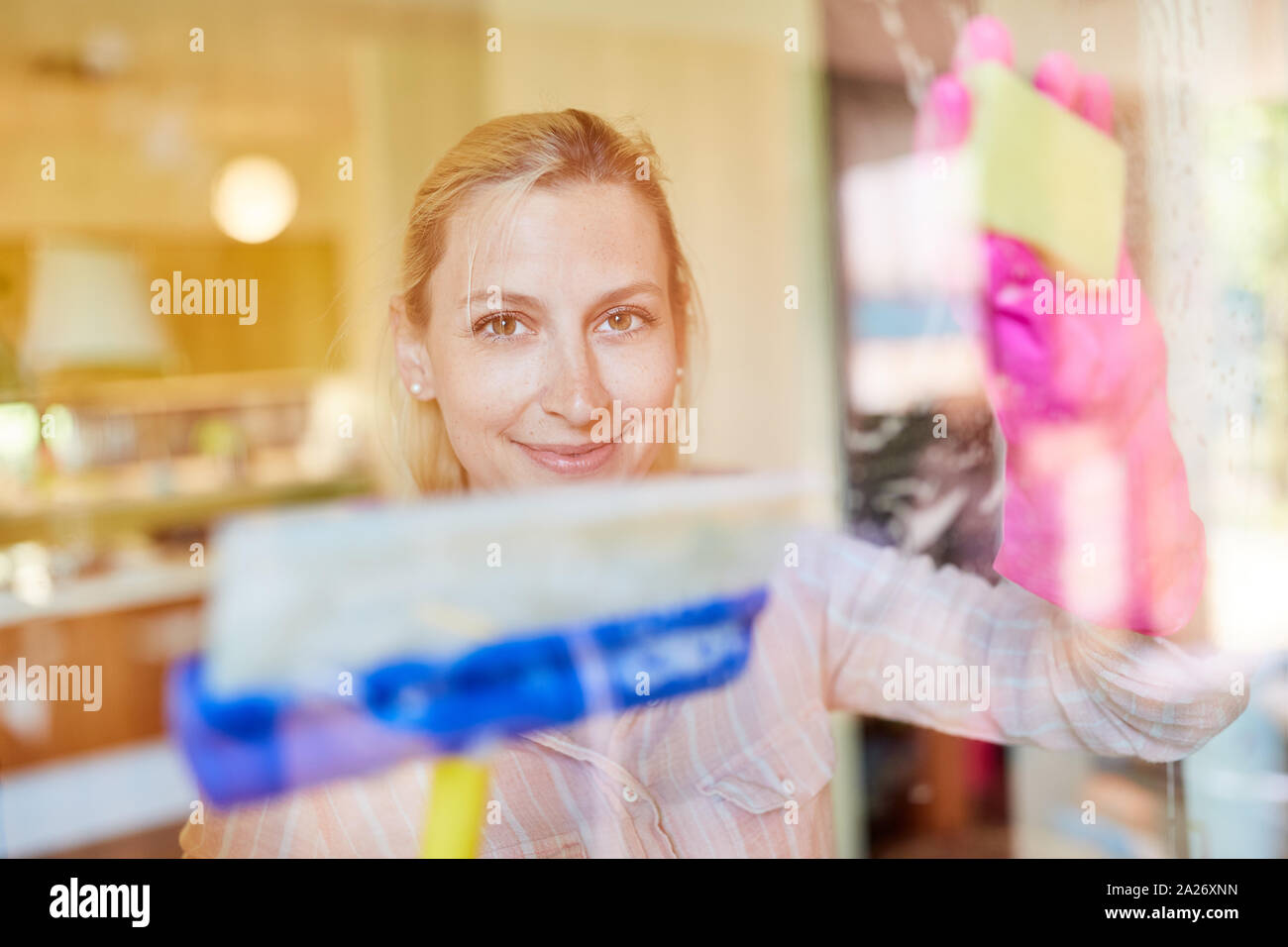 Cleaning lady at streak-free window cleaning at home Stock Photo - Alamy