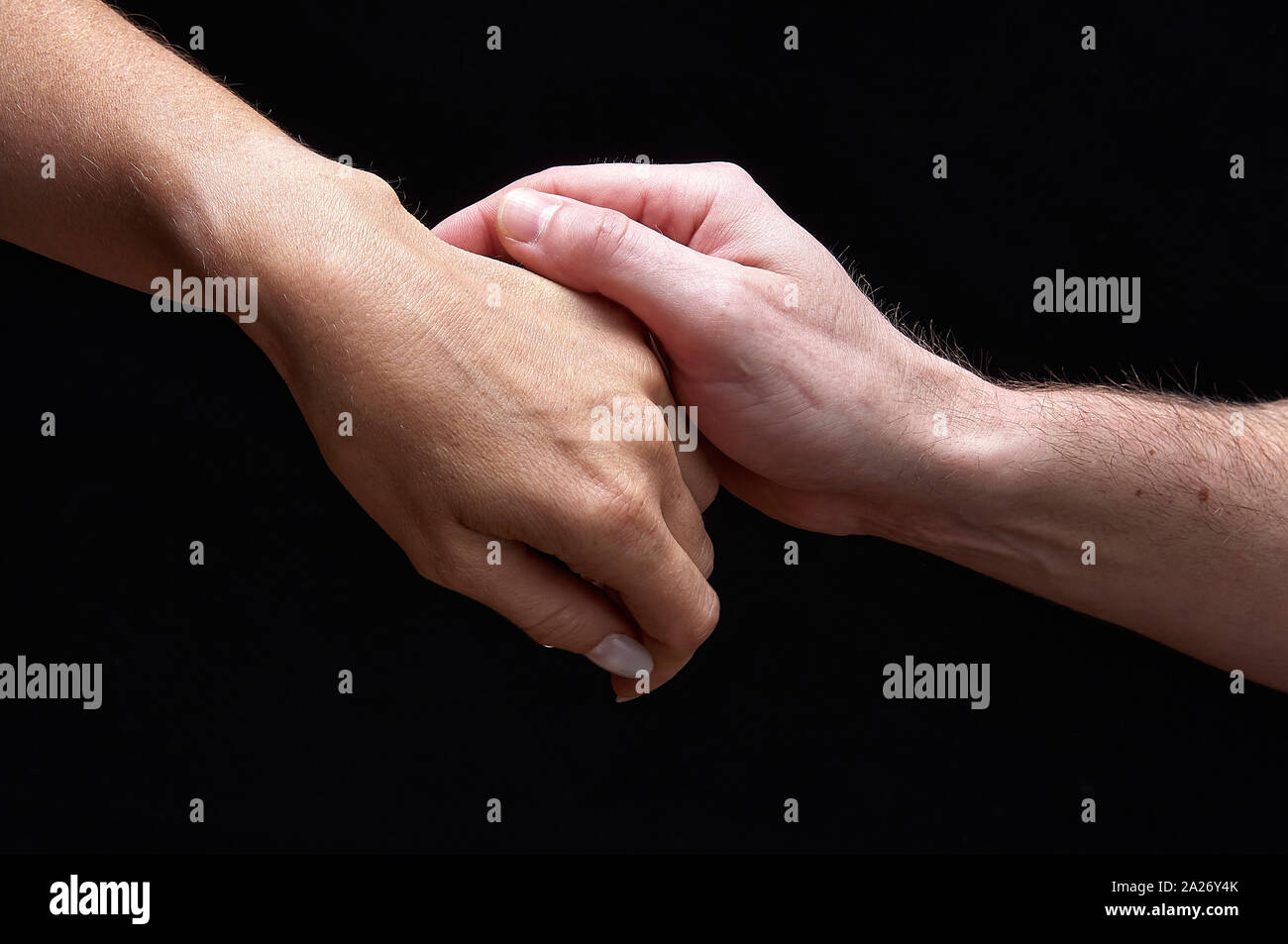 Male and female hands together showing emotions on black background ...