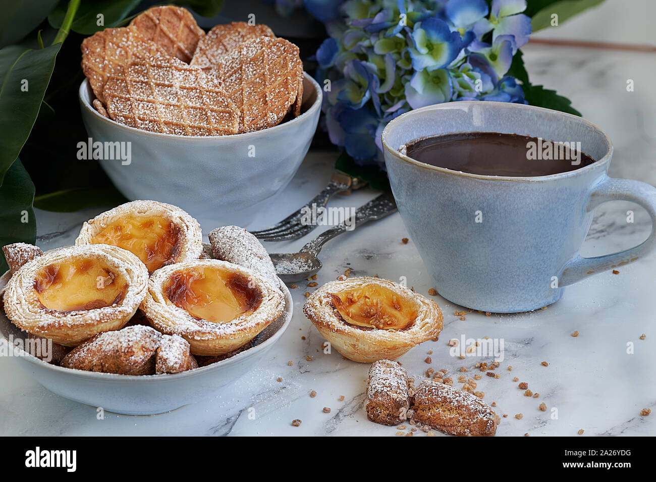 Puff pastry and English cream cakes accompanied by a cup of chocolate ...