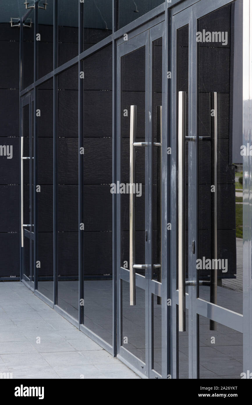 Side-view of glass doors - entrance to modern office building Stock ...