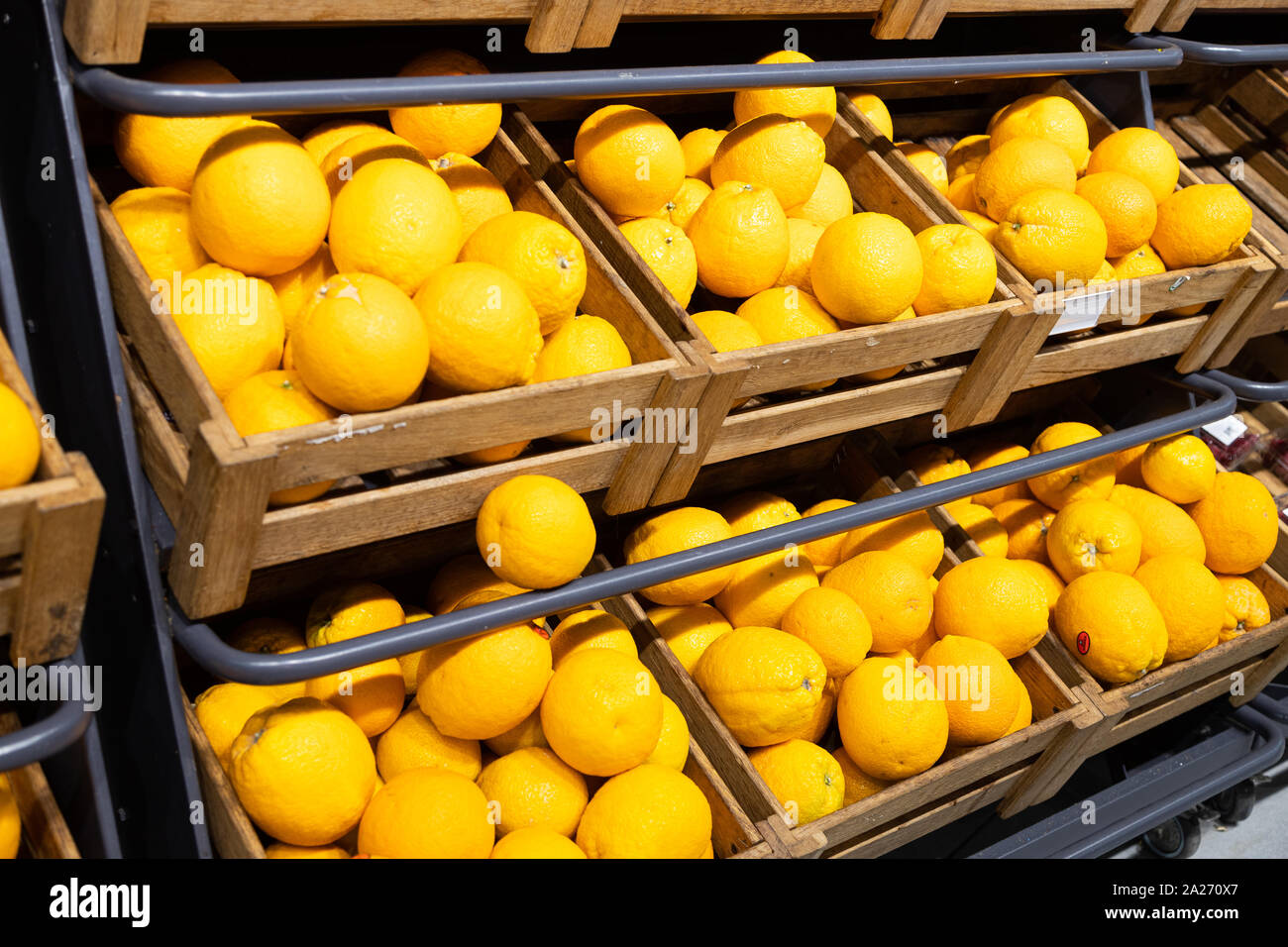 Many wooden lug boxes with fresh yellow lemons on counter Stock Photo ...