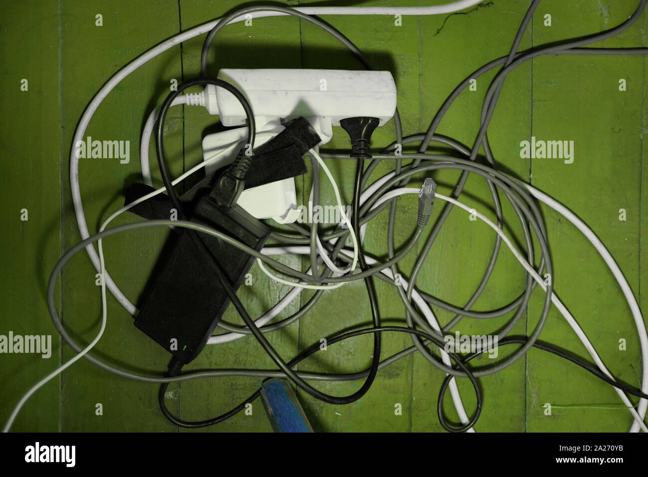 Electric wires left in mess on the floor, overhead shot Stock Photo - Alamy