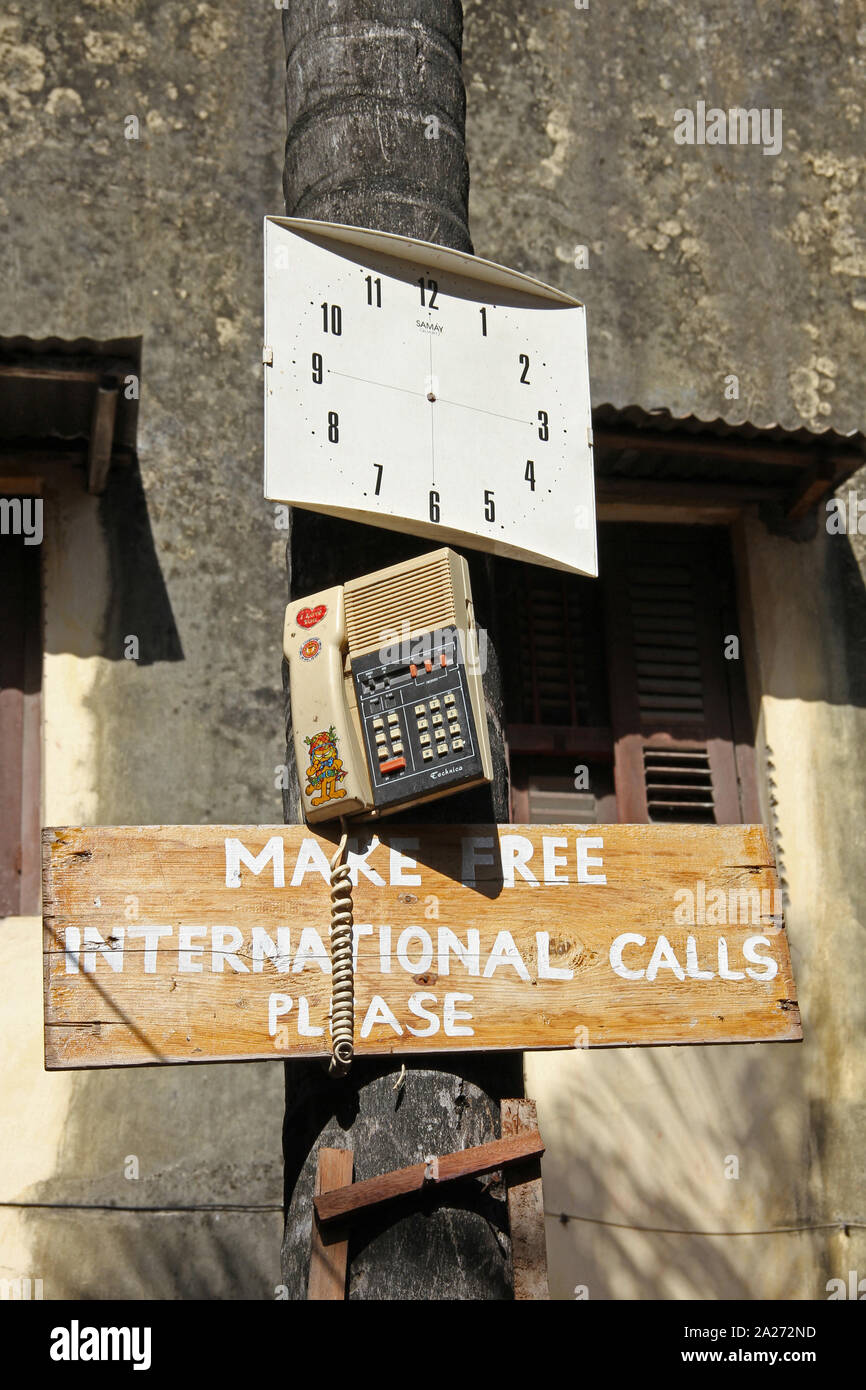 Clock with public telephone used for free internartional calls and sign ...