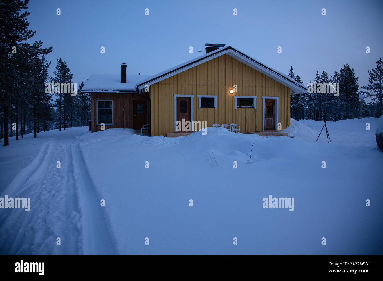 Timber built house in thick snow in northern Finland during winter ...