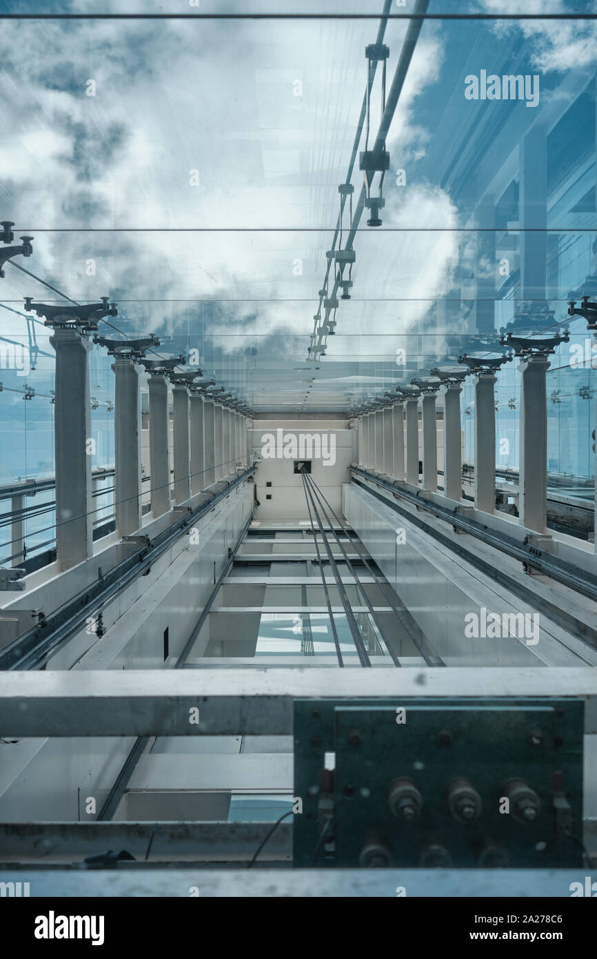 interior view from below of modern transparent elevator or lift with ...