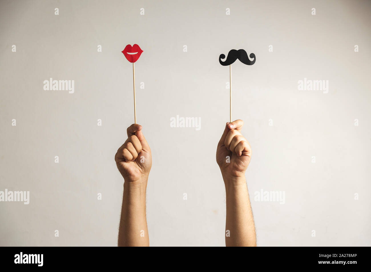 Hands holding up Photo booth props lips and Black Mustache Stock Photo ...