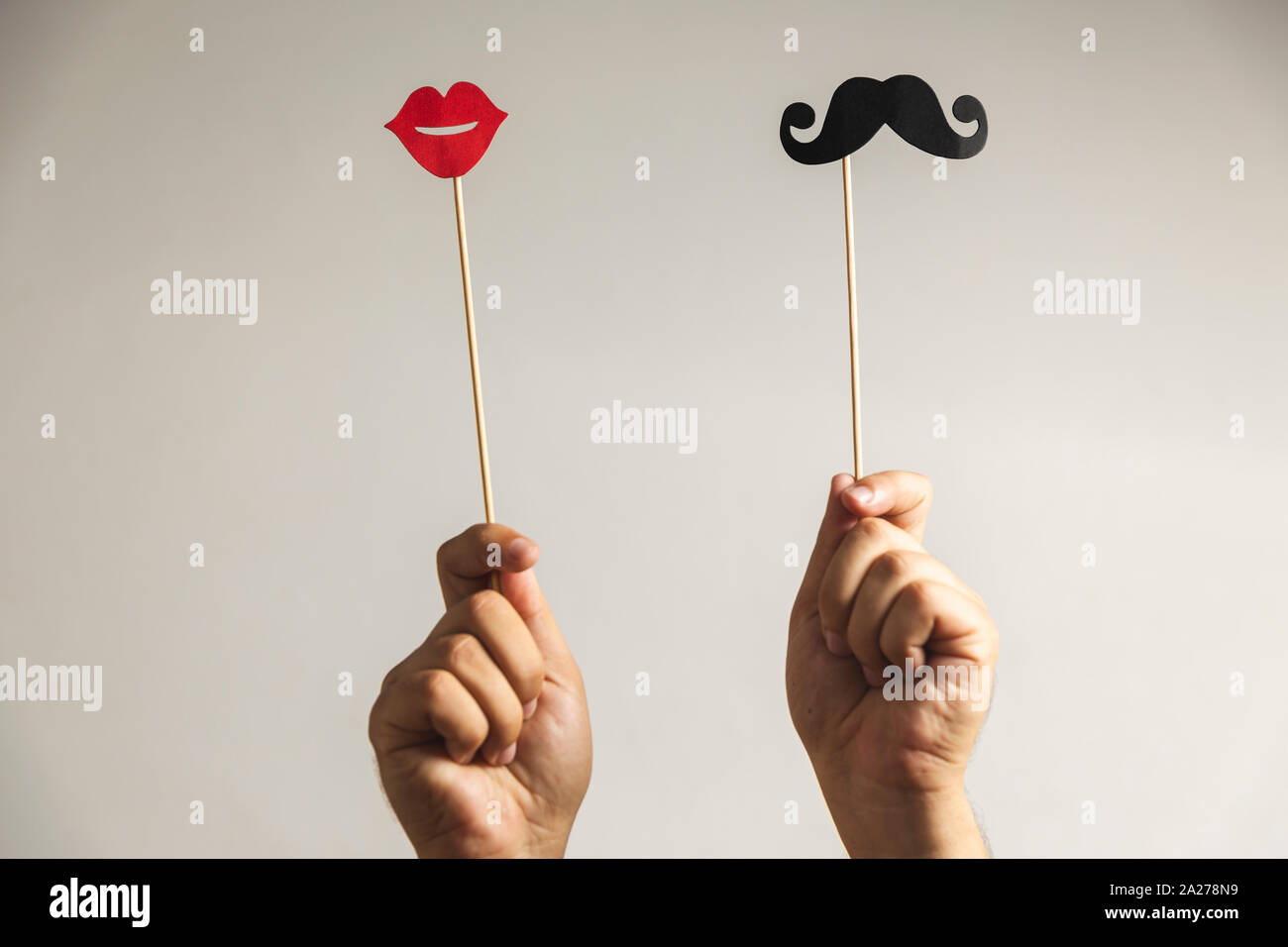 Hands holding up Photo booth props lips and Black Mustache Stock Photo ...
