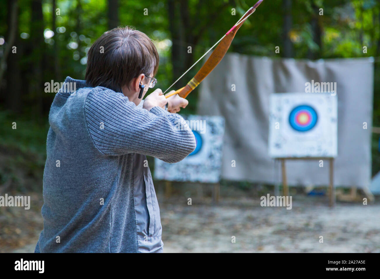 Male archer with wooden bow Stock Photo - Alamy