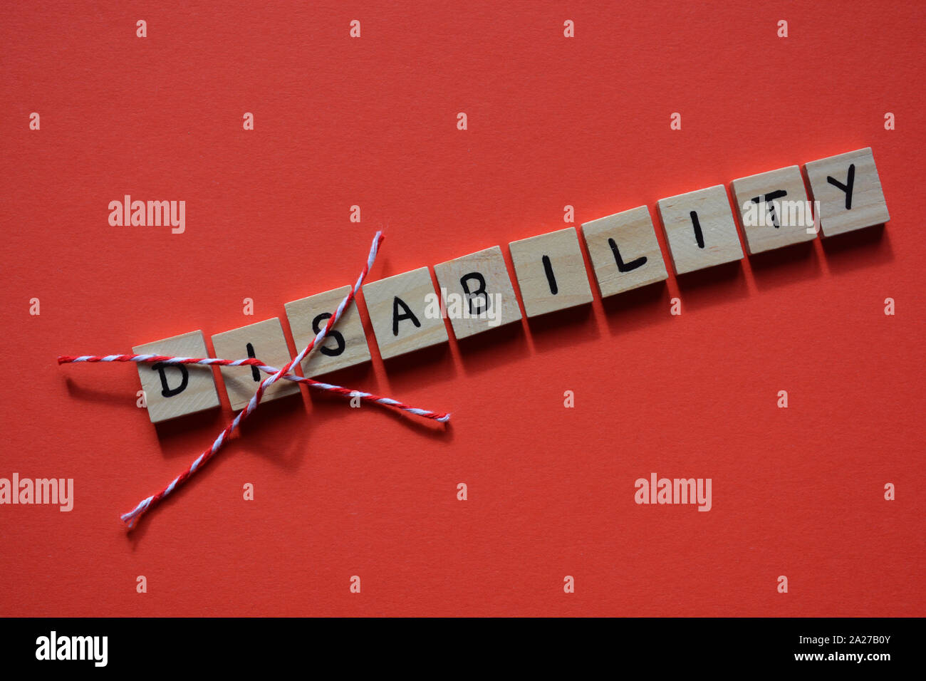 Disability in 3d wooden letters, with Dis crossed out, leaving the word ...