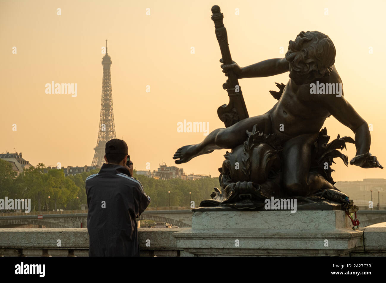 Statue of Nymphs with locks on Alexandre III bridge with Eiffel Tower ...