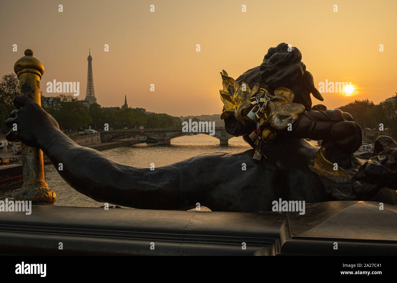 Statue of Nymphs with locks on Alexandre III bridge with Eiffel Tower ...