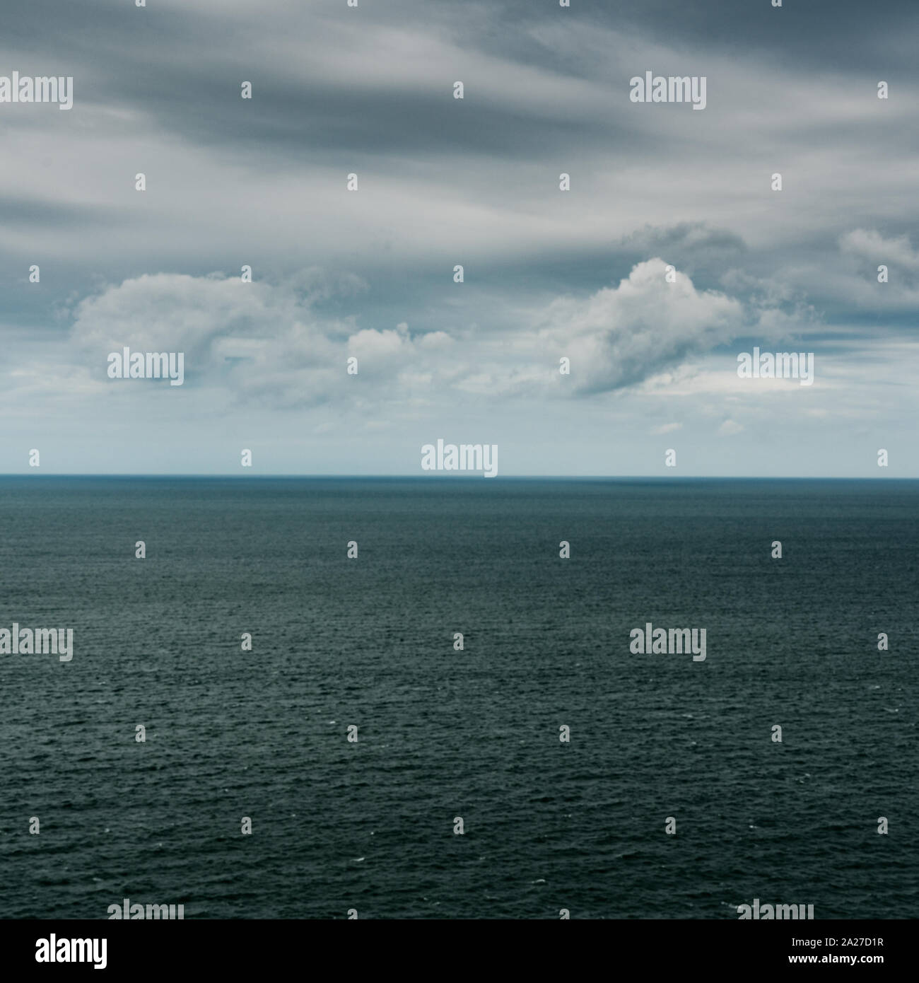 Square format view of empty ocean and sky landscape with expressive ...