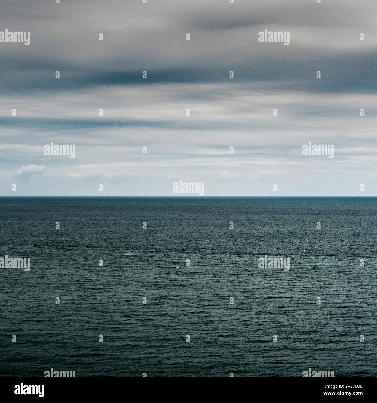 Square format view of empty ocean and sky landscape with expressive ...