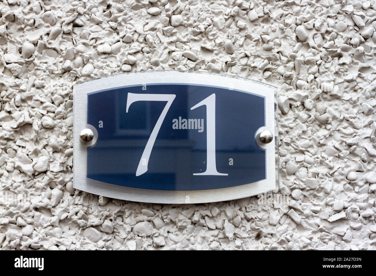 House number 71 on a structured plaster wall Stock Photo - Alamy