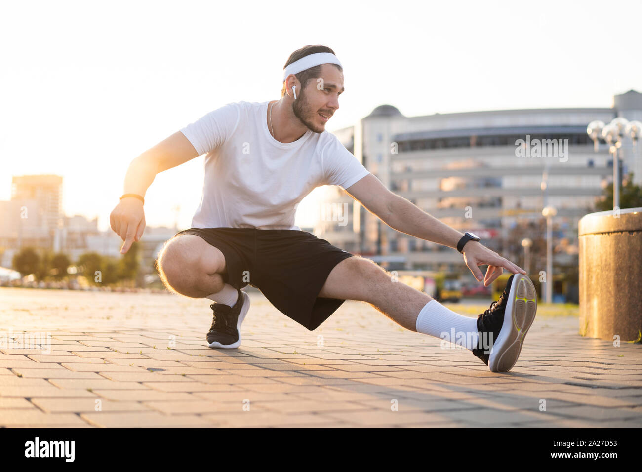 Man stretching muscles at the city park hi-res stock photography and ...