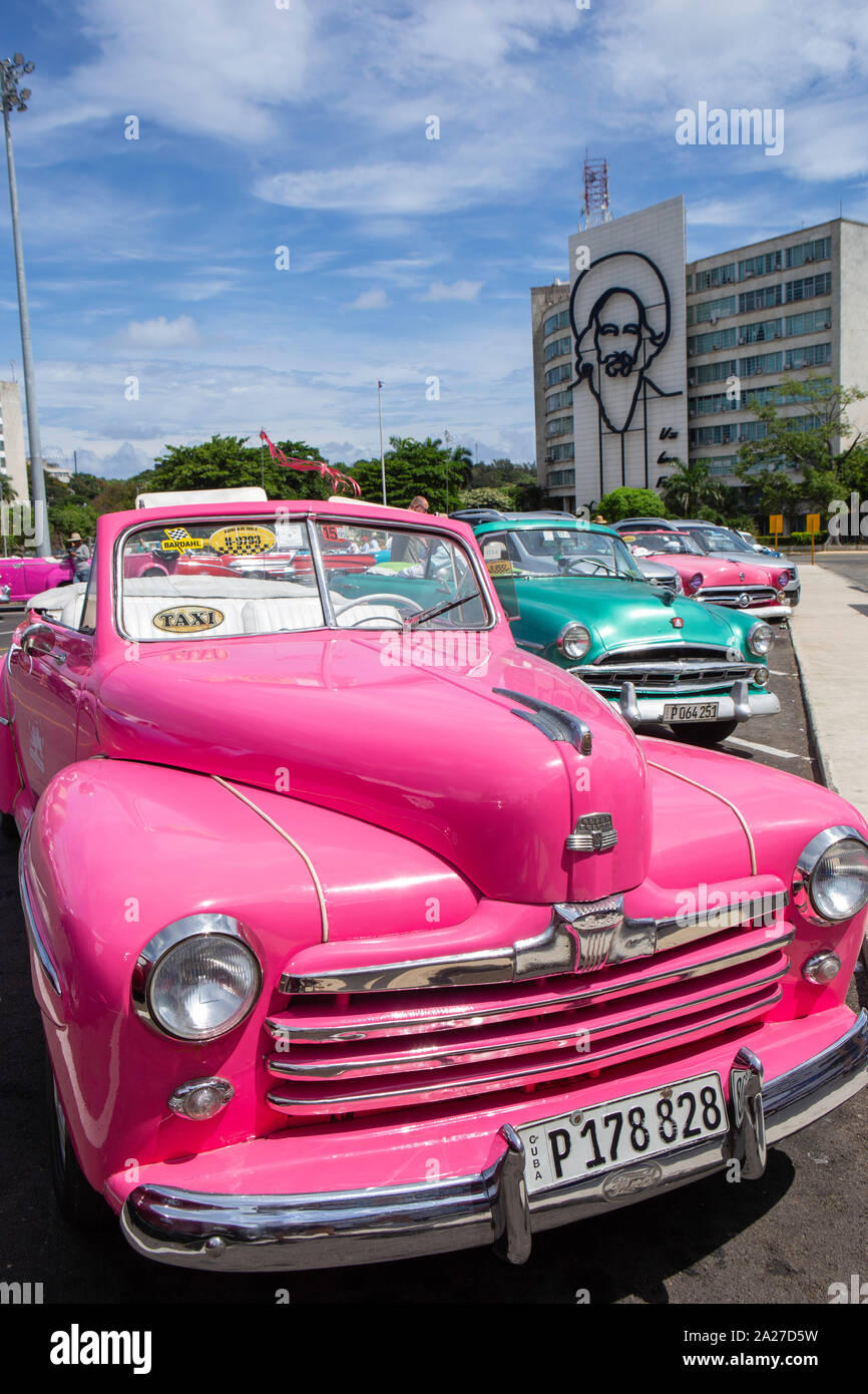Pink convertible parked in the Revolution Square in Havana Cuba with a ...