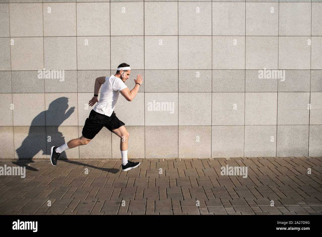 Handsome man running in the city. Fitness, workout, sport, lifestyle ...
