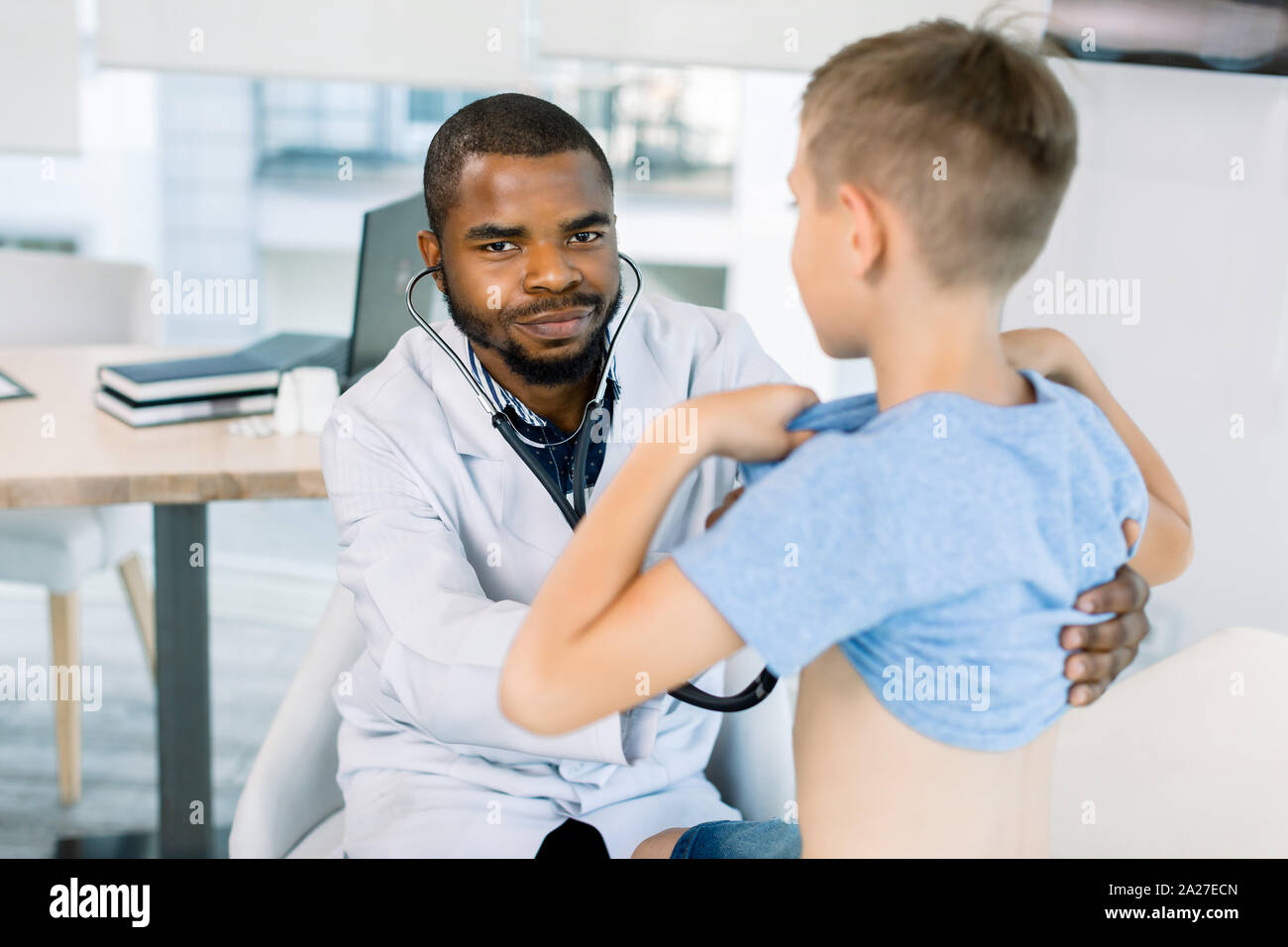 African male doctor and child boy patient. Smiling pediatrician man ...