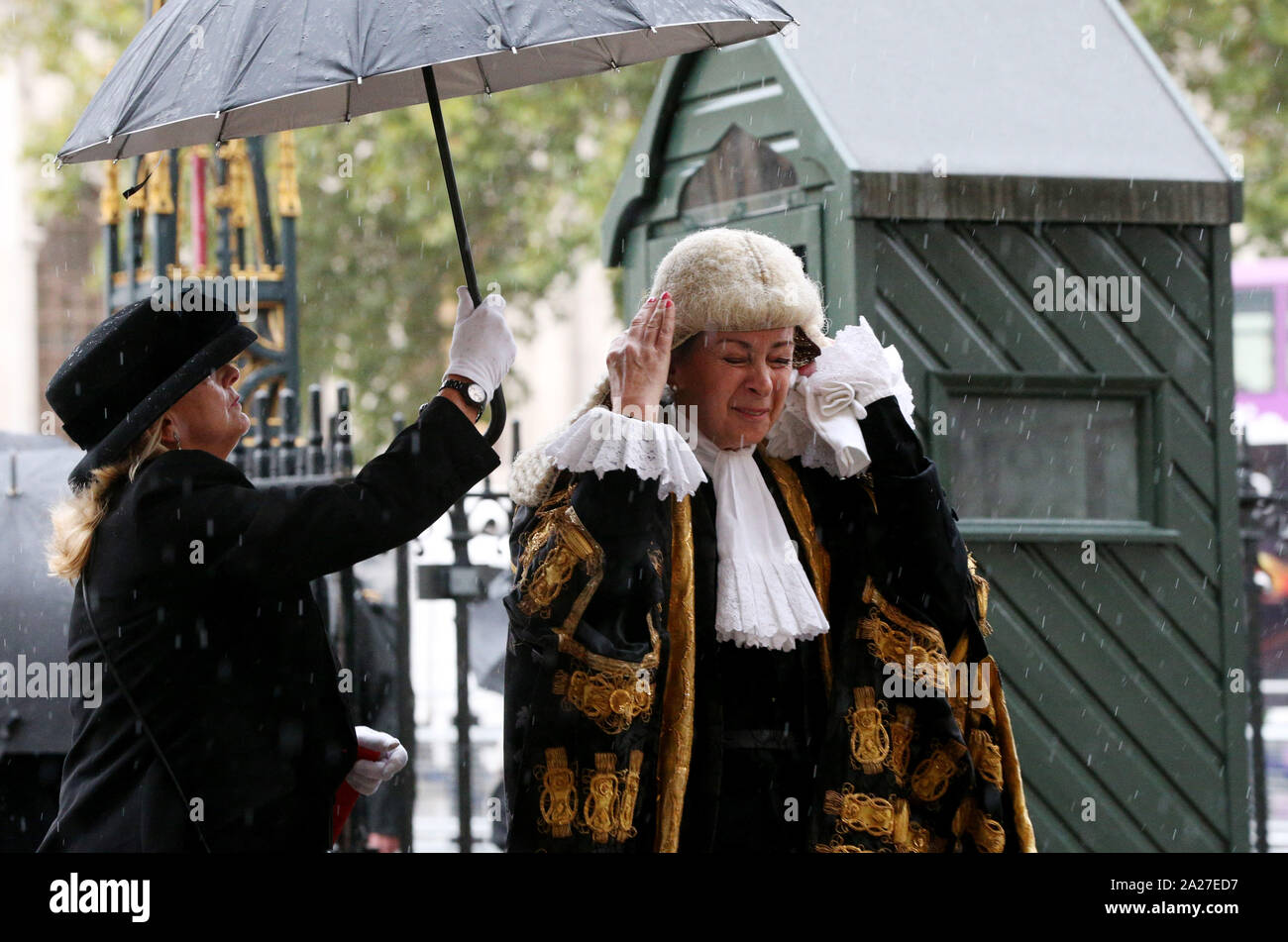 Lady Justice Macur (right) has an umbrella held over here whilst ...