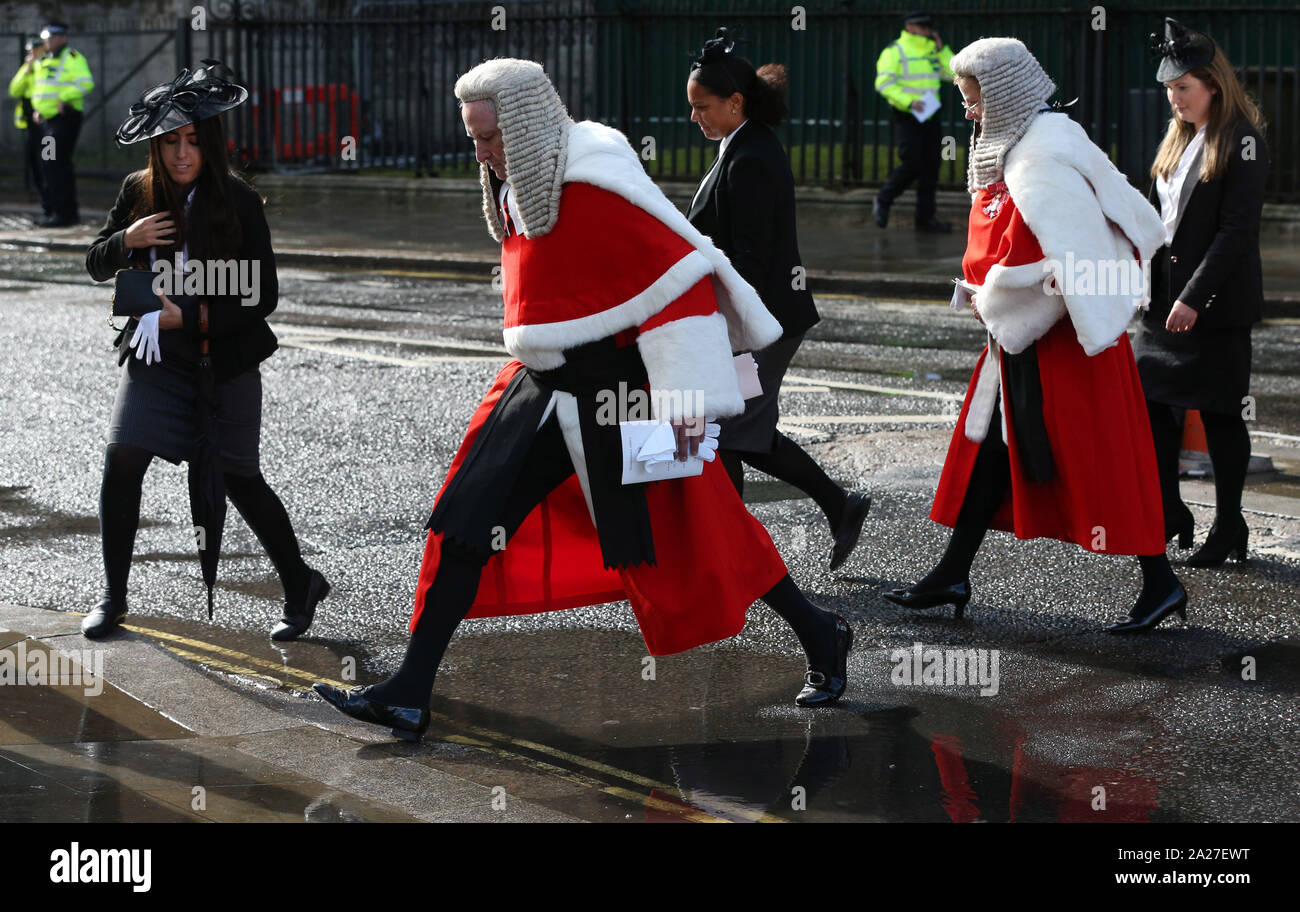 A High Court judge jumps over a puddle after leaving the annual Judges ...