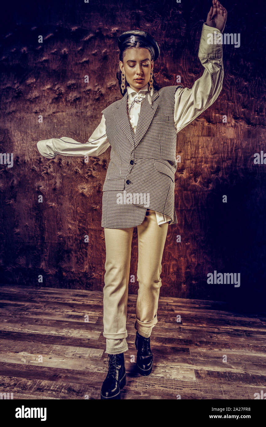 Model with hands up modelling beside dark background Stock Photo - Alamy