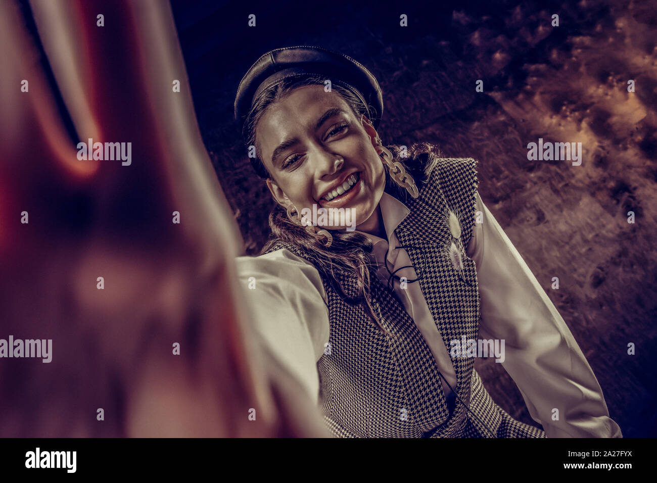 Low angle of a beautiful female looking into camera Stock Photo - Alamy