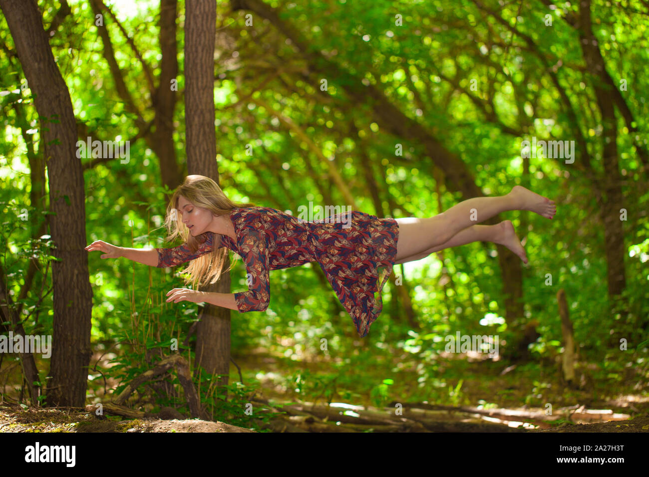 he concept of levitation. The girl flies through the woods. Man in ...