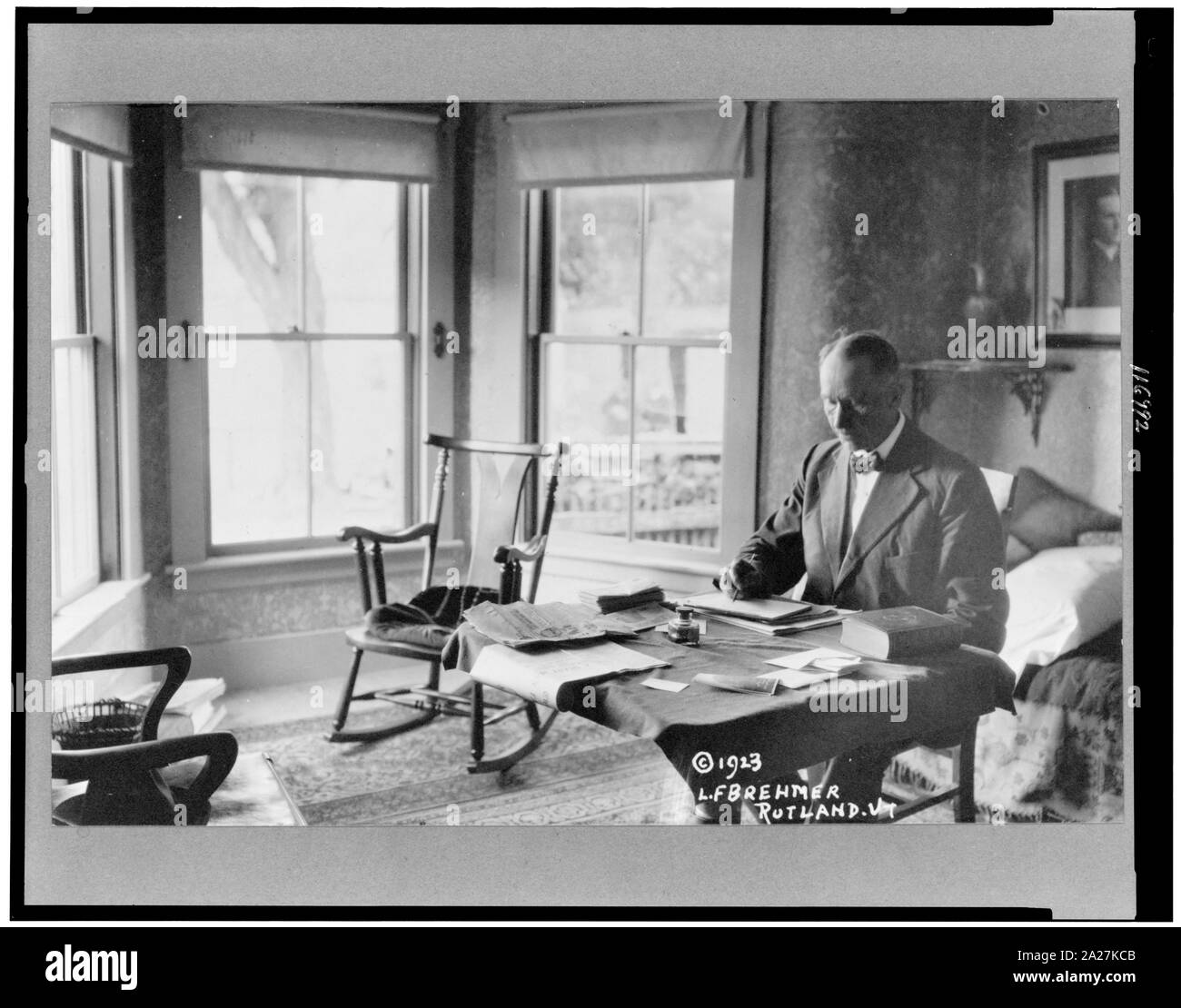 President Calvin Coolidge, half-length portrait, seated at desk in ...