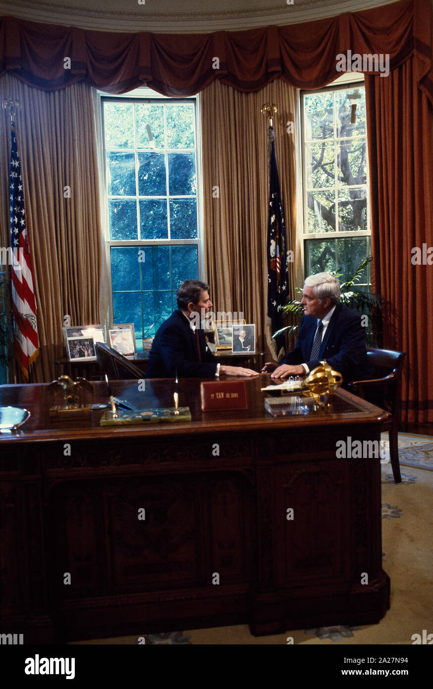 President Ronald Reagan talks to Republican Senators at his desk in the ...
