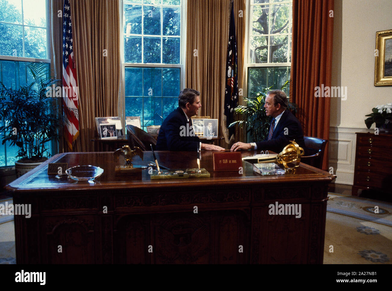 President Ronald Reagan talks to Republican Senators at his desk in the ...