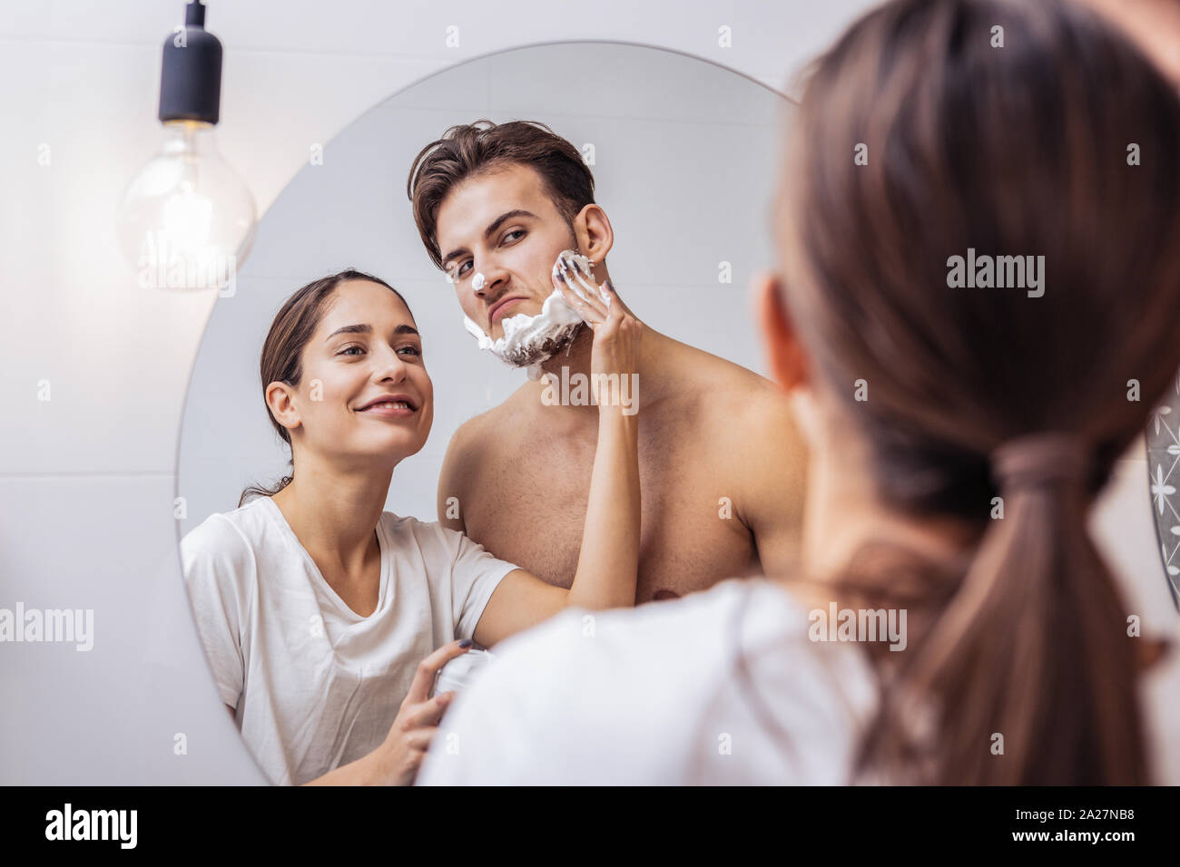 Handsome husband helping happy hi-res stock photography and images - Alamy