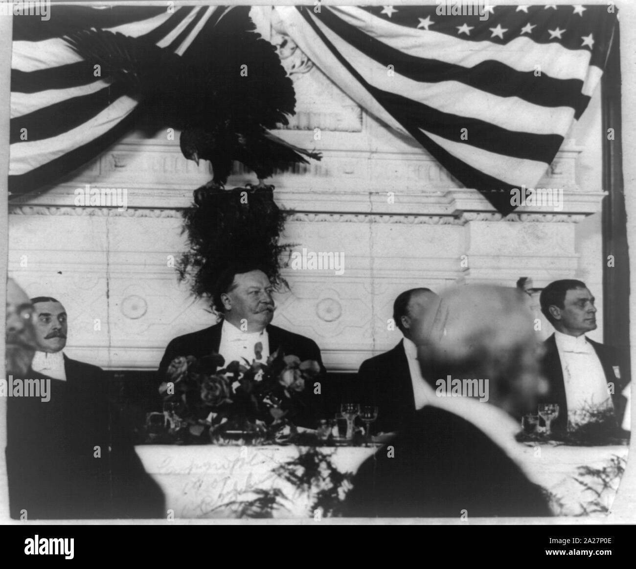 President Taft at dinner, with eagle and U.S. flag behind him Stock ...