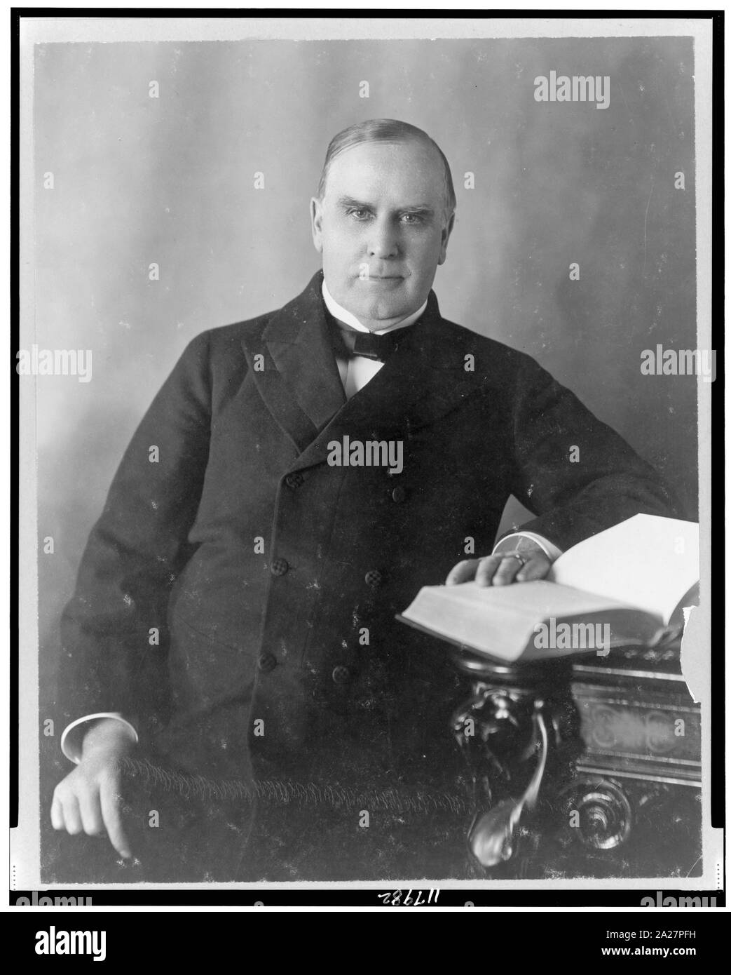 President William McKinley, half-length portrait, seated at desk ...