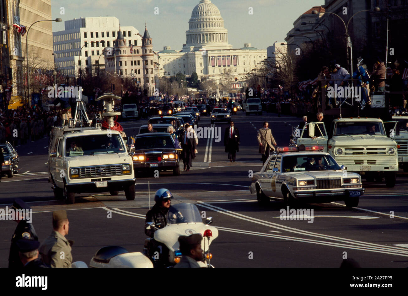 President and Mrs. Bush are walking right behind the first car during ...