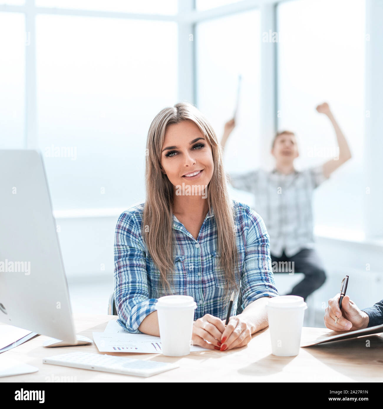 young employees sitting at a Desk in the office Stock Photo - Alamy