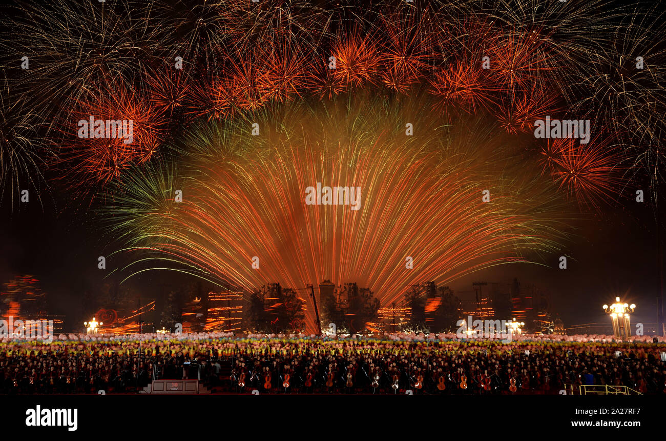 Beijing, China. 1st Oct, 2019. Fireworks explode during a grand evening ...