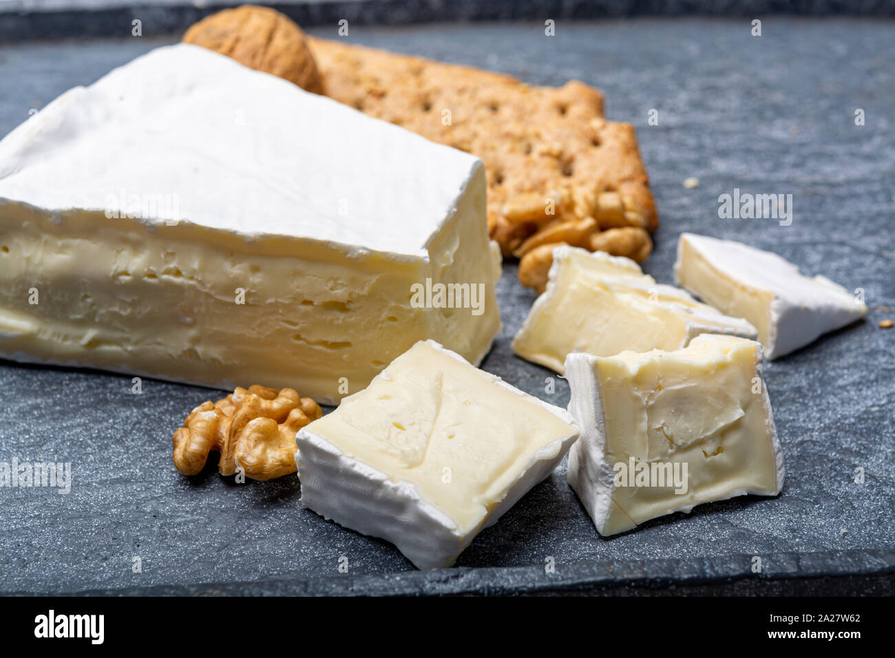 Cheese collection, piece of French brie cheese with white mold close up ...
