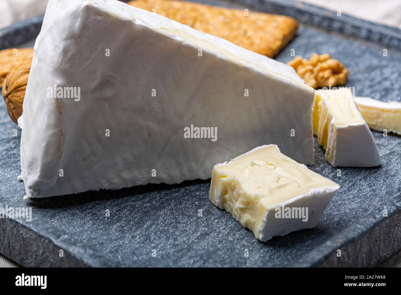 Cheese collection, piece of French brie cheese with white mold close up ...