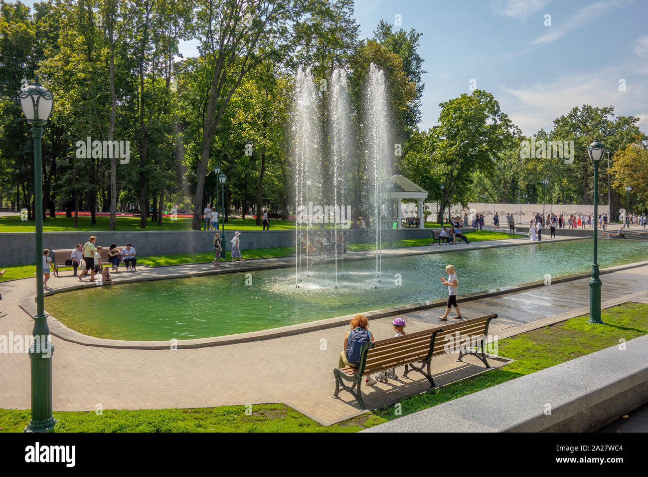 Kharkiv, Ukraine, August, 2019 People walk in a park, sit on benches ...