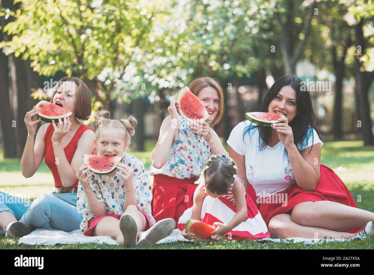 Summer - big happy family at a picnic with watermelon. Fun juicy summer ...