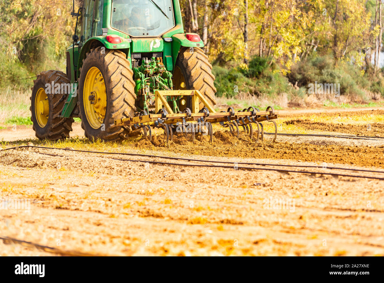 rural landscape, tractor cultivates agricultural land Stock Photo - Alamy