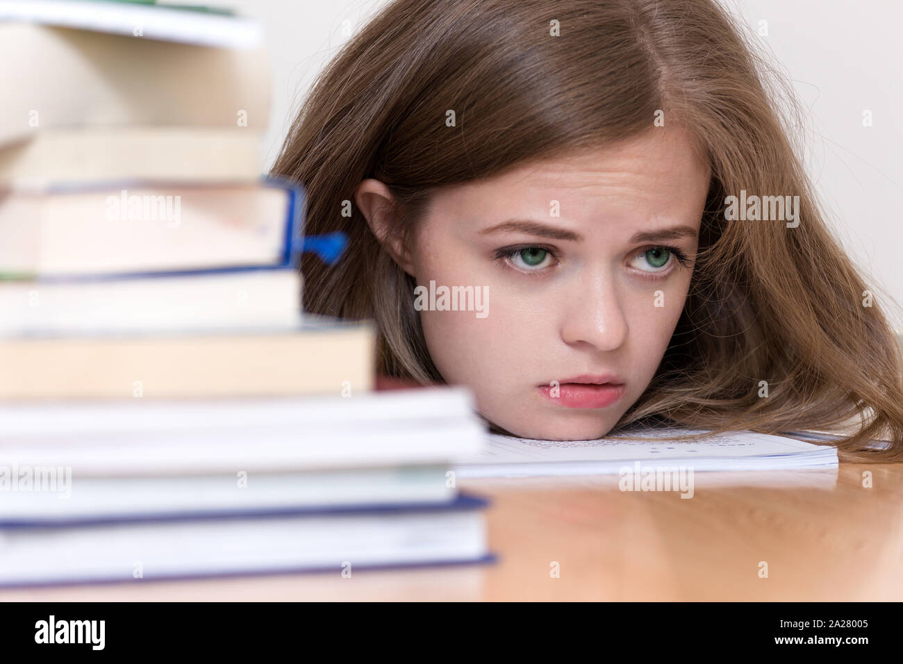 Young caucasian girl woman with many books study at school or ...