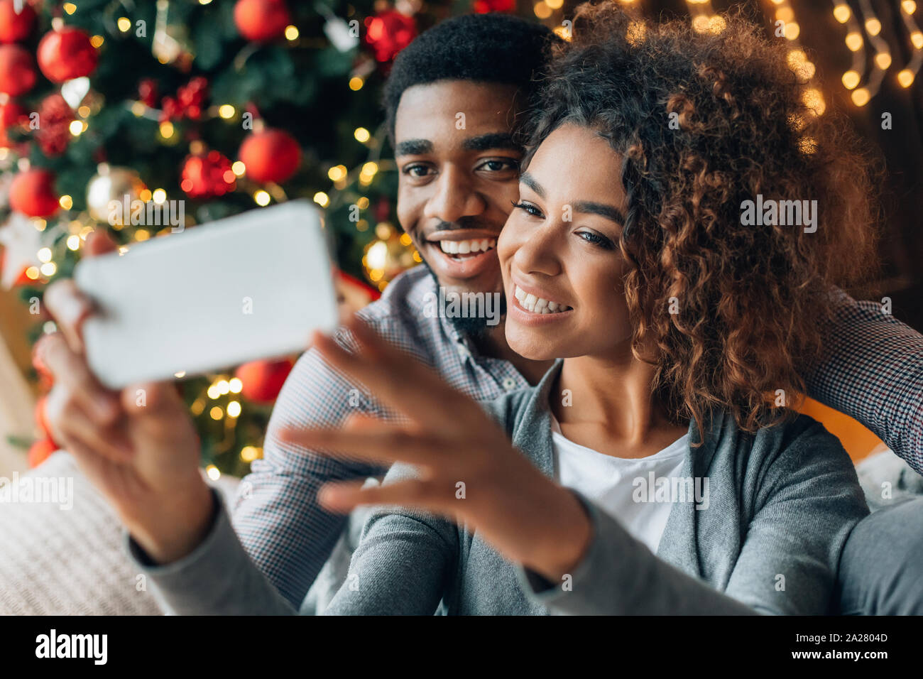 Young smiling family christmas tree hi-res stock photography and images ...