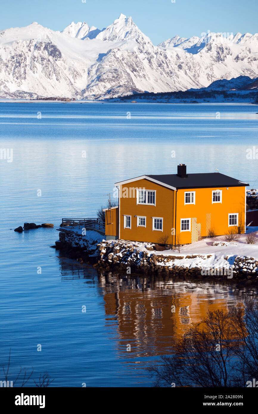 traditional norwegian yellow wooden house to stand at the lakeside and ...