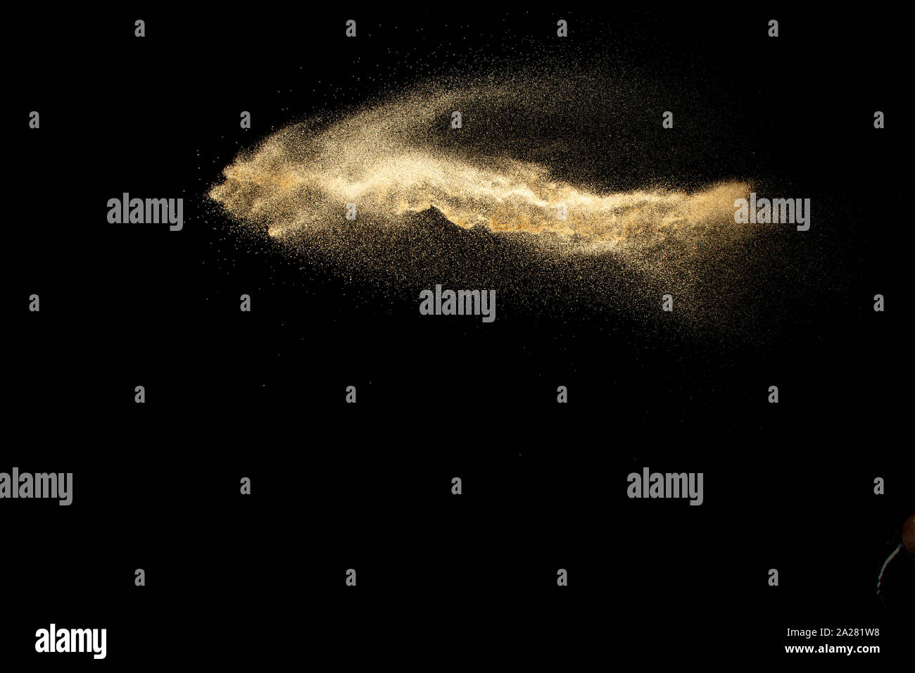 Sand explosion isolated on black background. Freeze motion of sandy ...