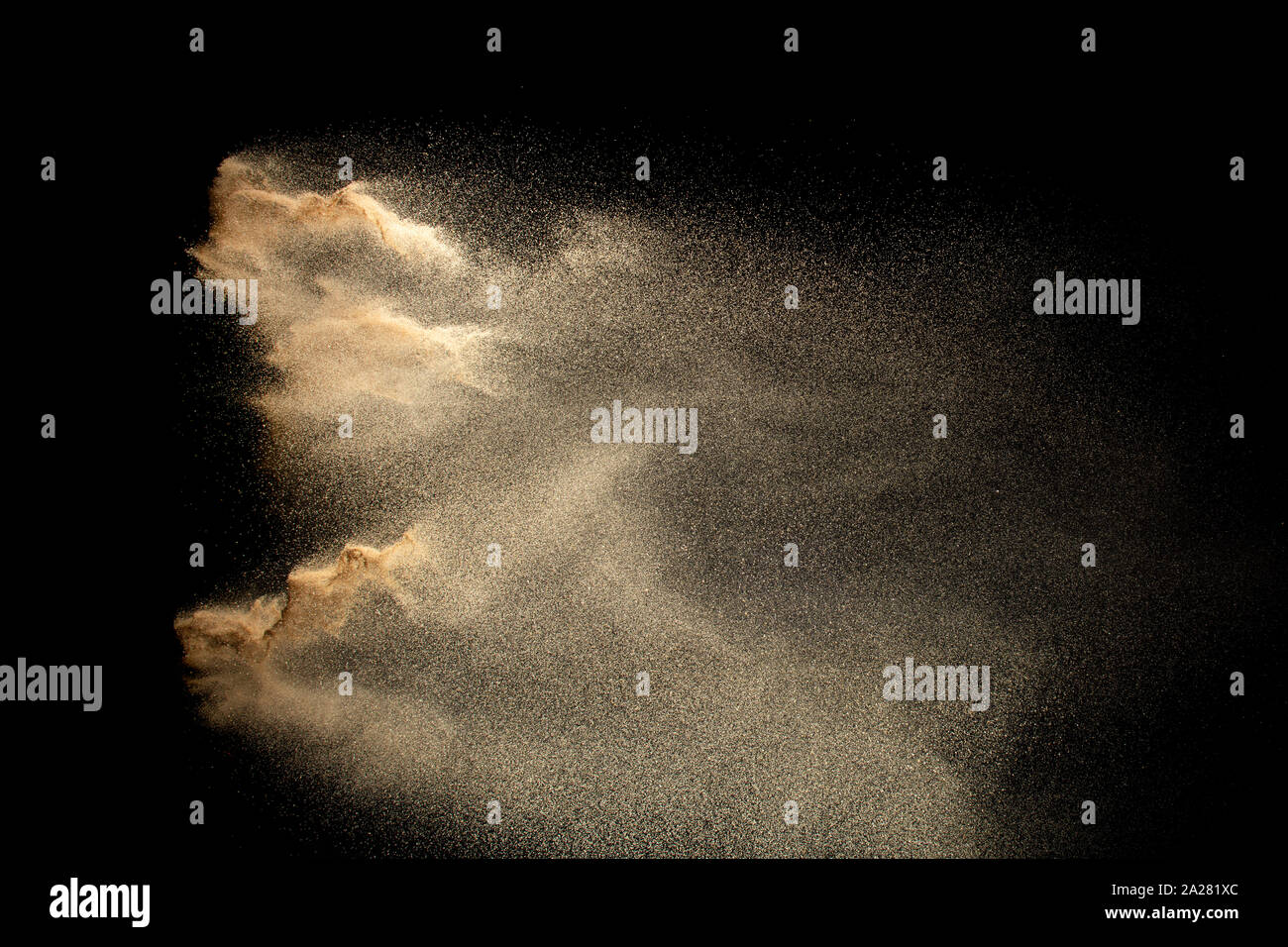 Sand explosion isolated on black background. Freeze motion of sandy ...
