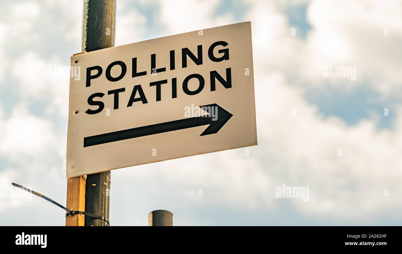 Sign outside a Polling Station on election day. Sign on wall of polling ...