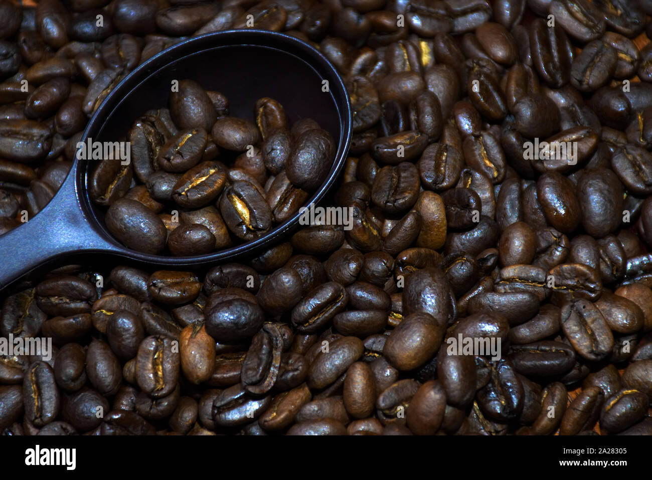 Coffee beans on a table with spoon Stock Photo - Alamy